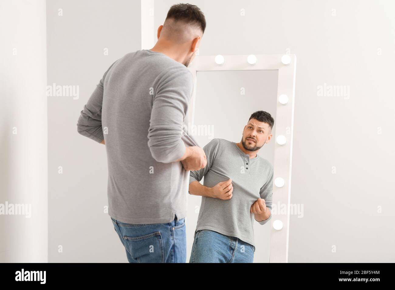 Man looking in mirror sad hi-res stock photography and images - Alamy