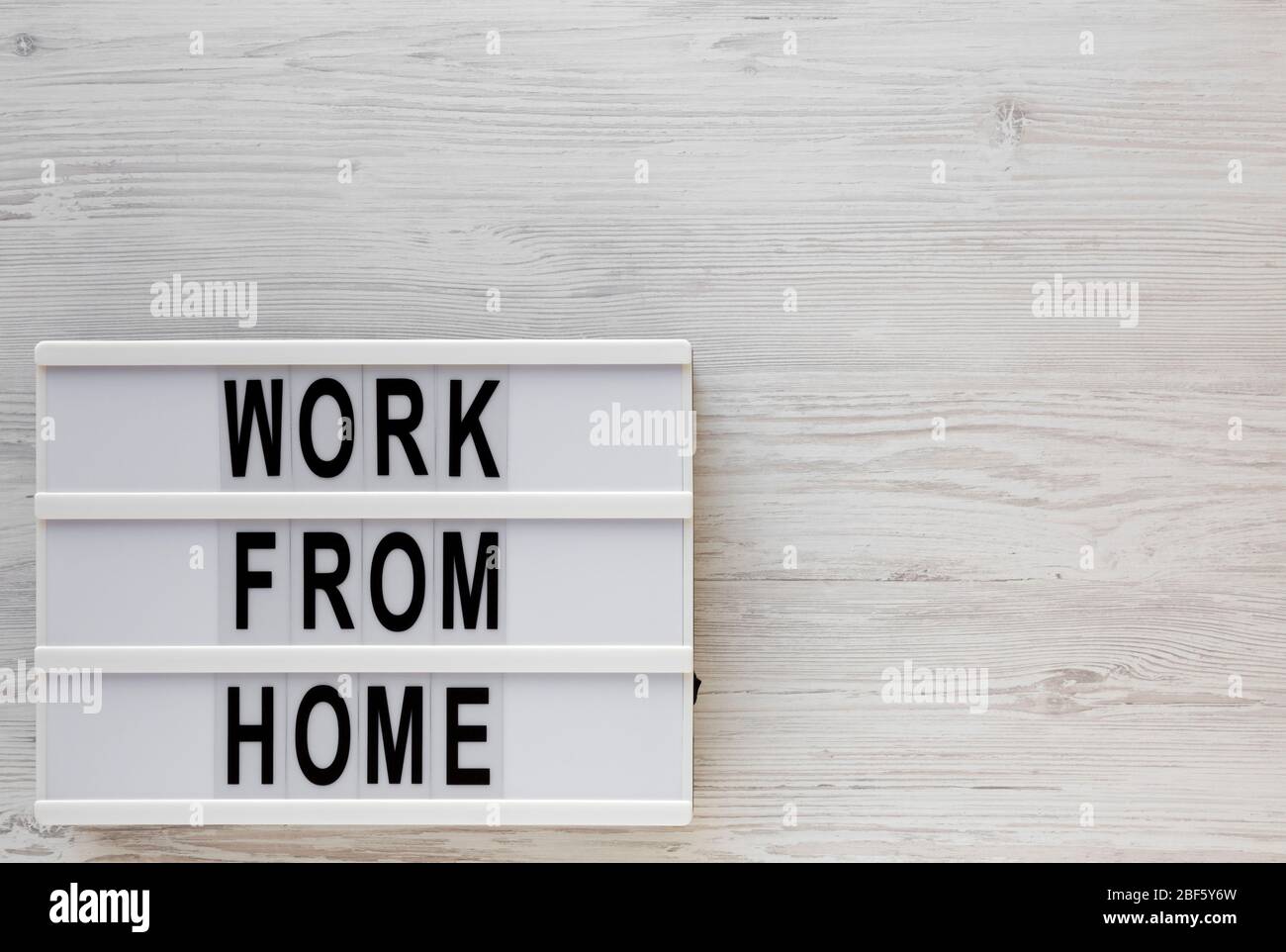 'Work from Home' words on a modern board on a white wooden background ...