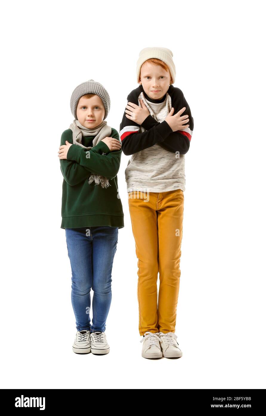 Cute little boys shaking with cold on white background Stock Photo - Alamy