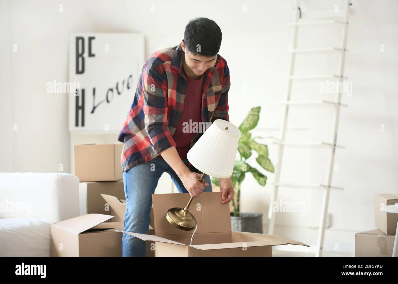 Asian man packing boxes hi-res stock photography and images - Alamy