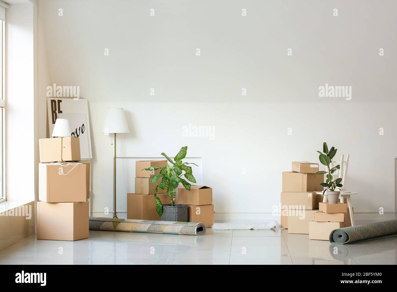 Moving boxes with belongings in room Stock Photo - Alamy