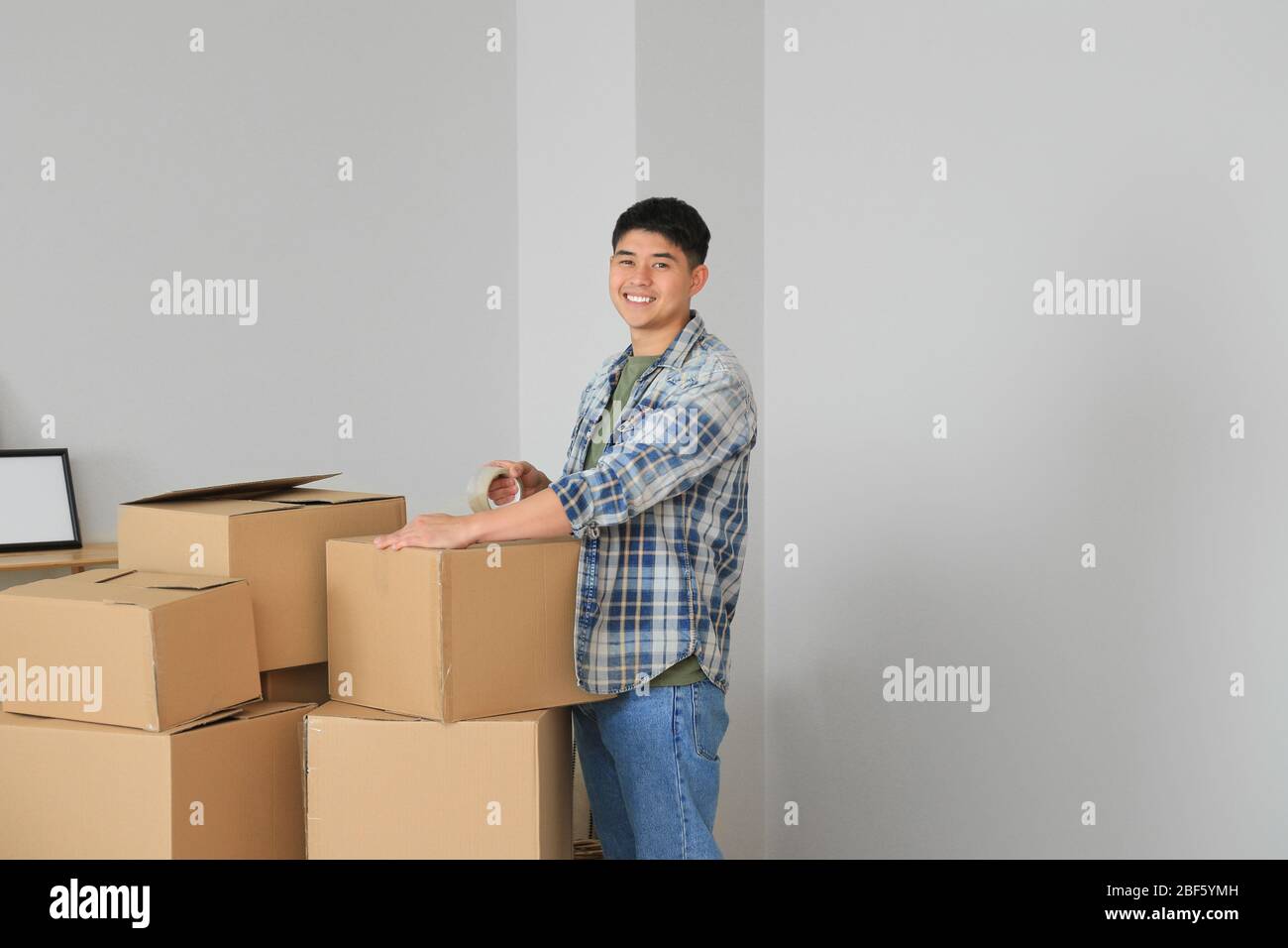 Asian man packing boxes hi-res stock photography and images - Alamy