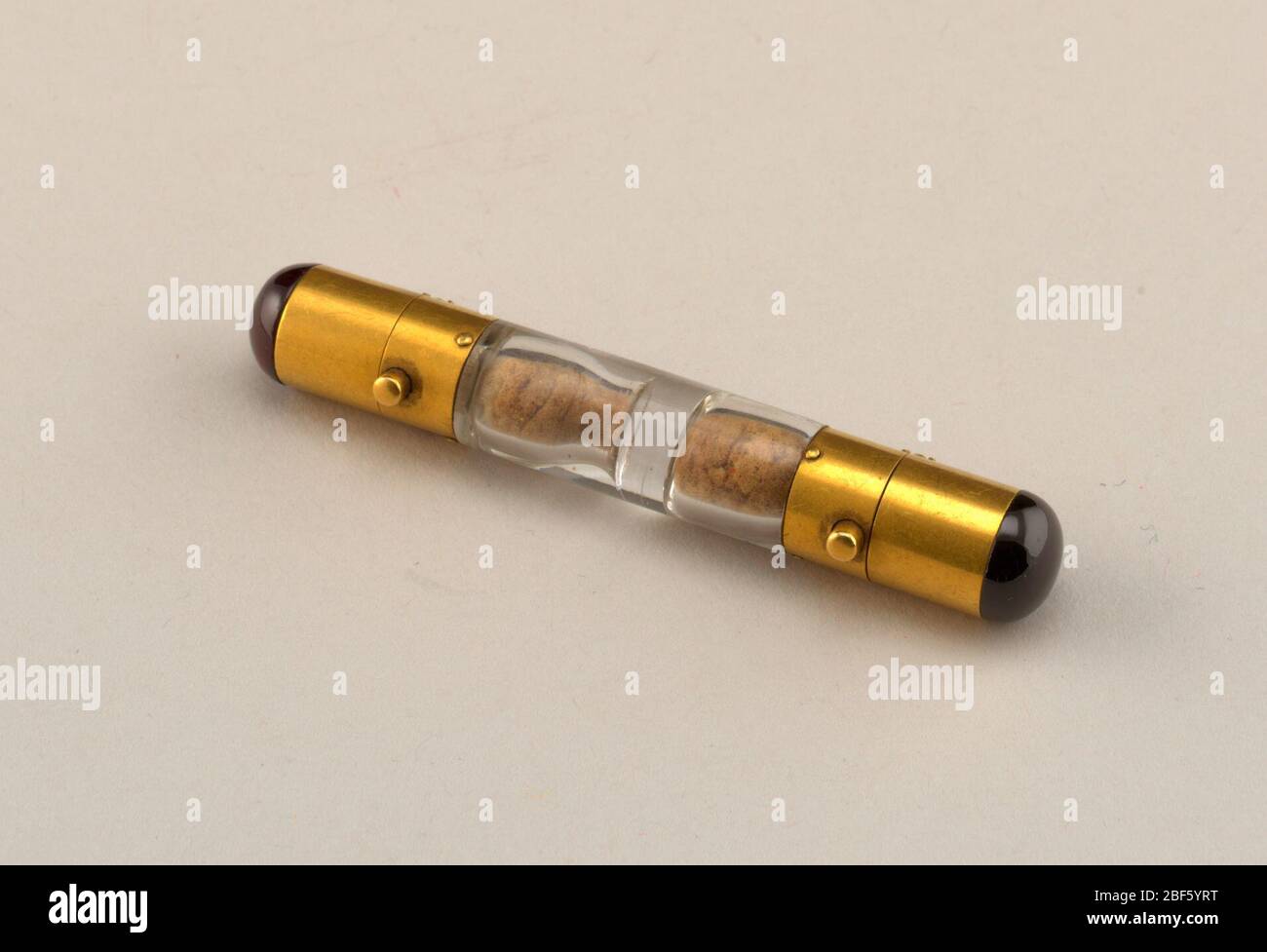 Scent flask. Bottle is cylindrical shape with glass wall in center ...