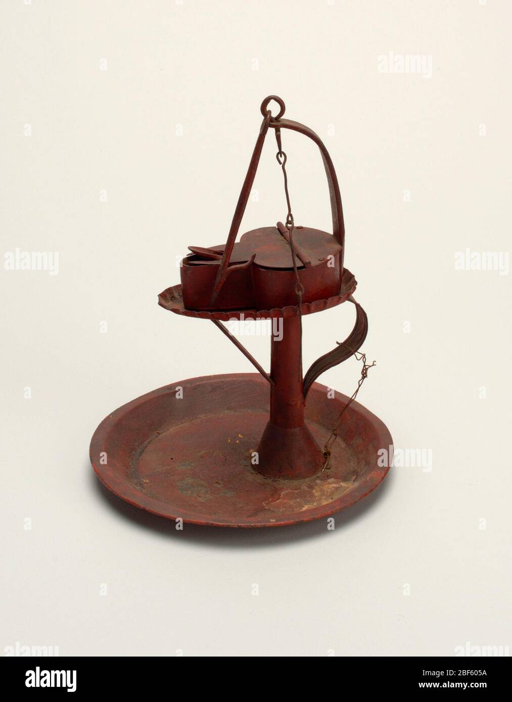 Stand. a: "Betty" lamp with hinged cover and handle rising from back ...