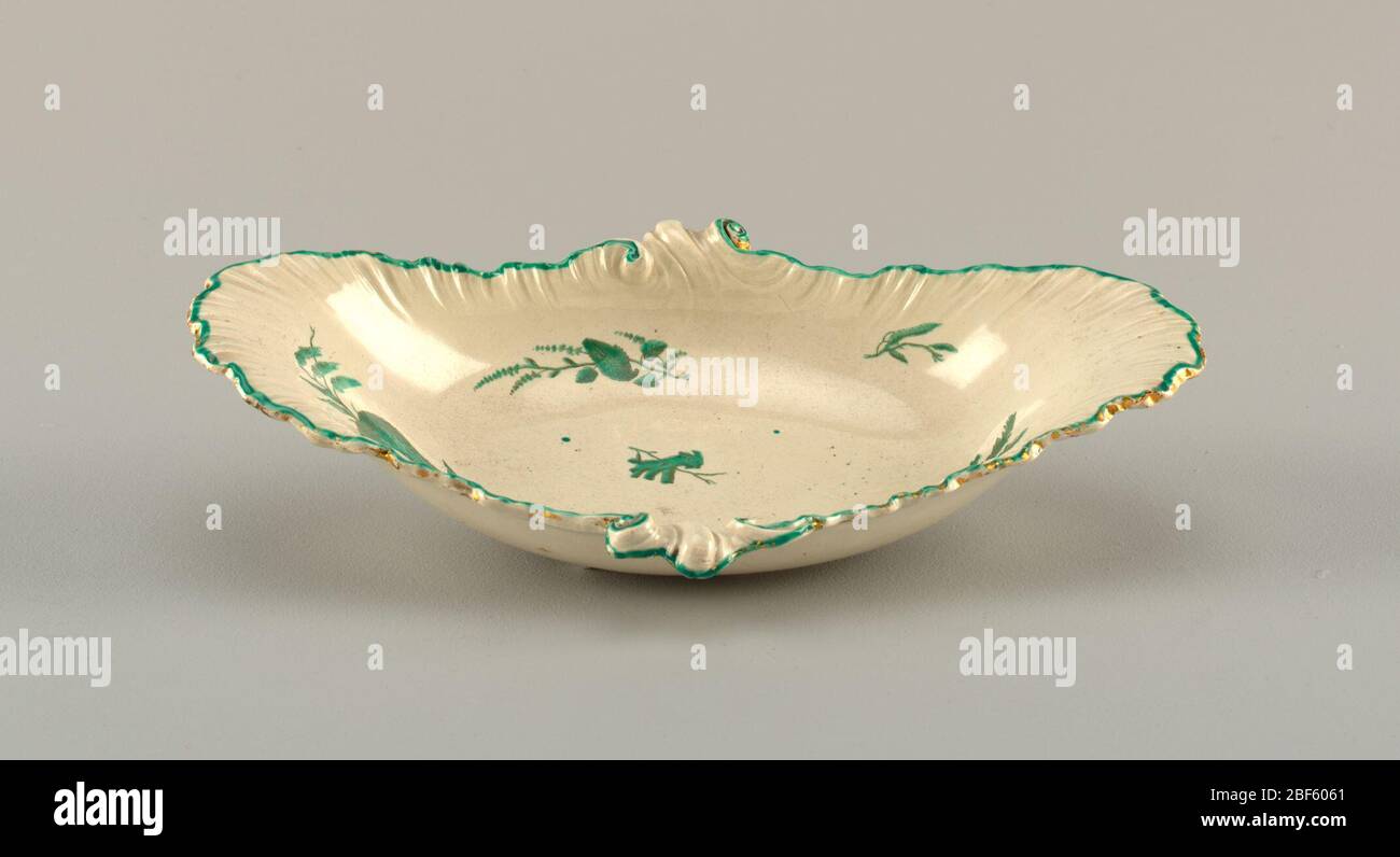 Dish. Oval dish wish scalloped border in the form of a shell. A line of ...