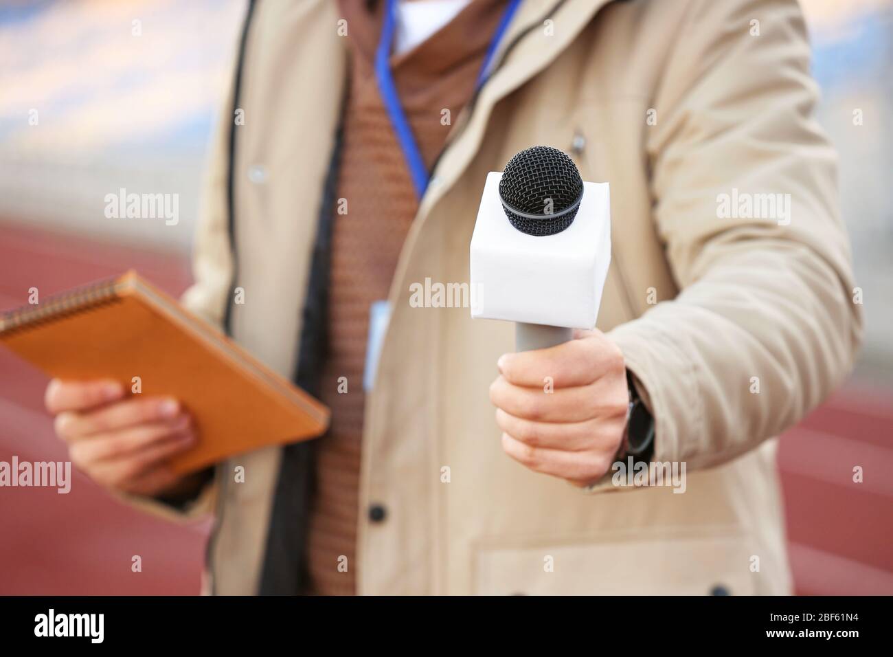 Male reporter with microphone at the stadium, closeup Stock Photo - Alamy