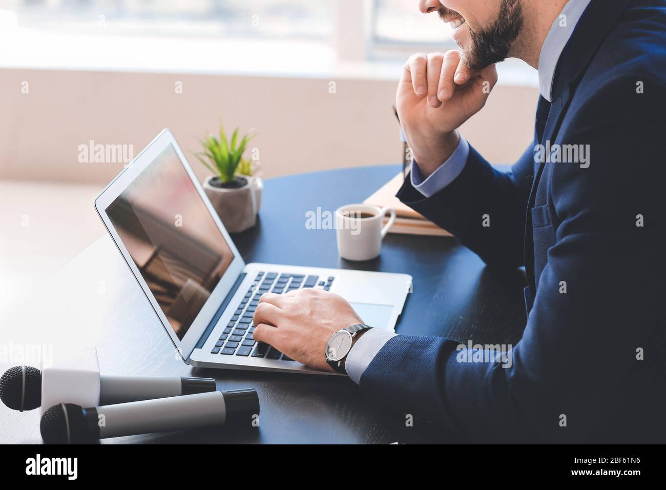 Male journalist working in office Stock Photo - Alamy