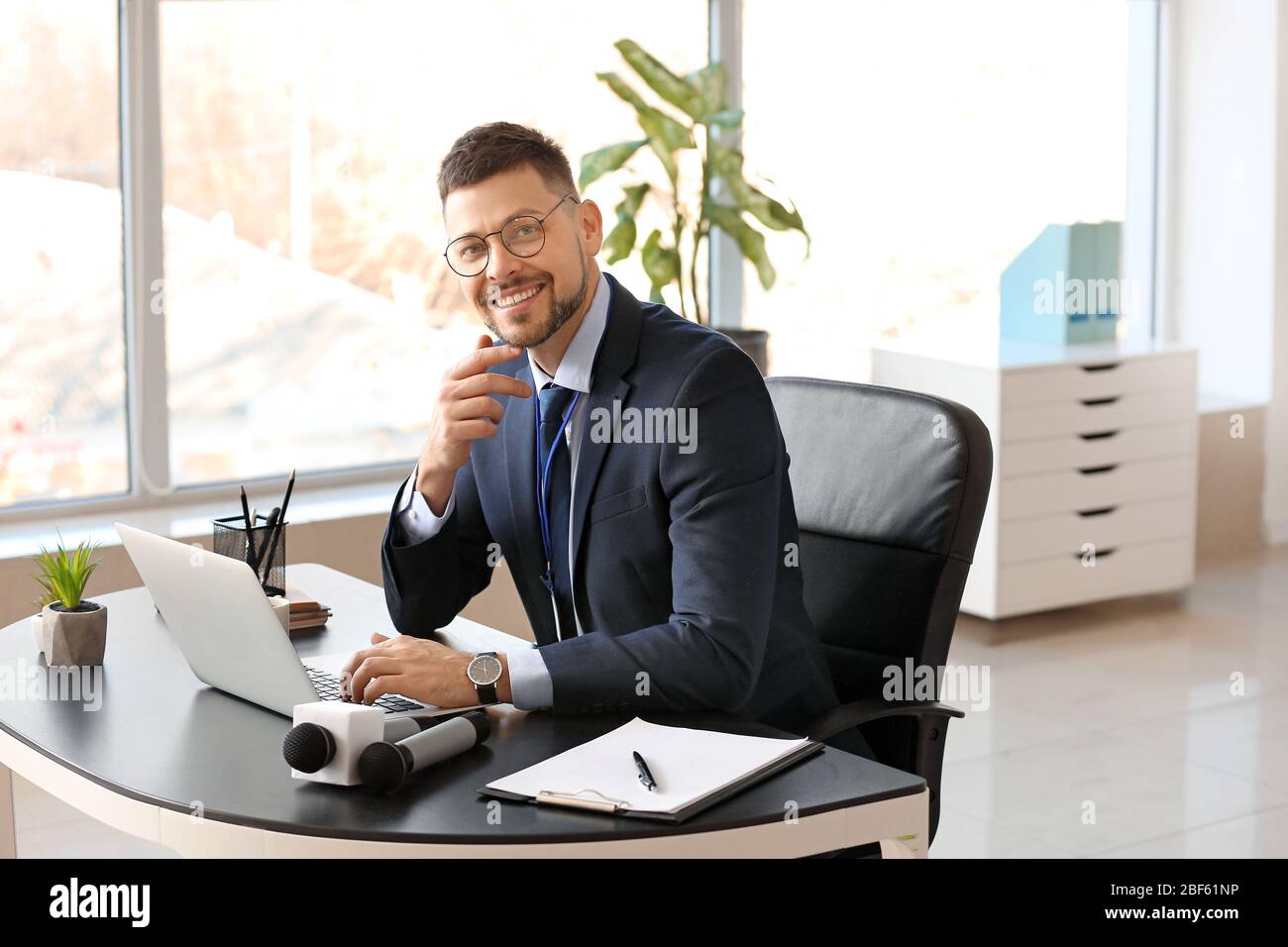Male journalist working in office Stock Photo - Alamy