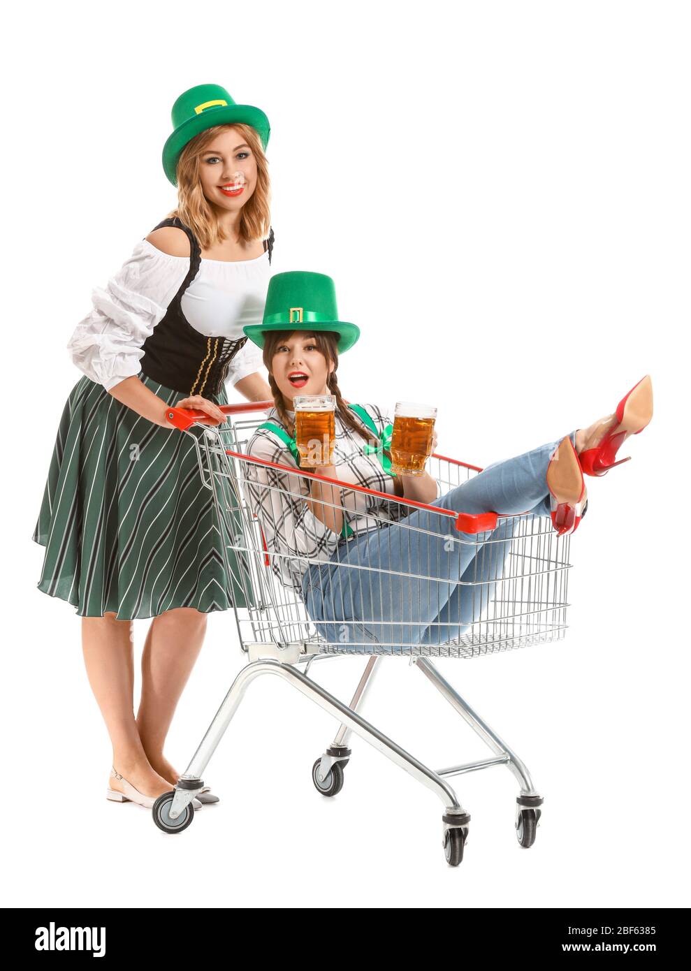 Funny young women with beer and shopping cart on white background. St ...