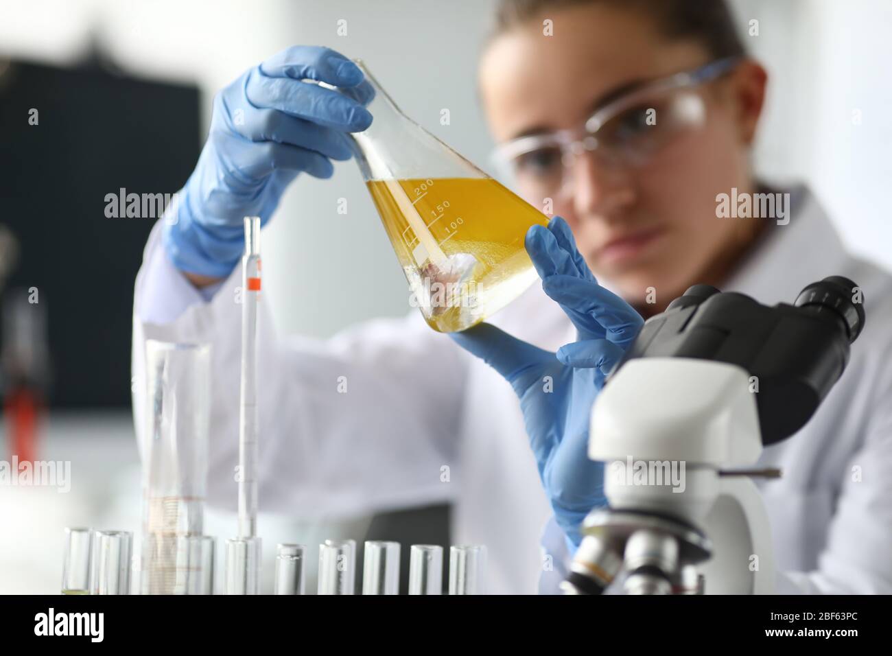 Scientist making experiments with mixture Stock Photo - Alamy