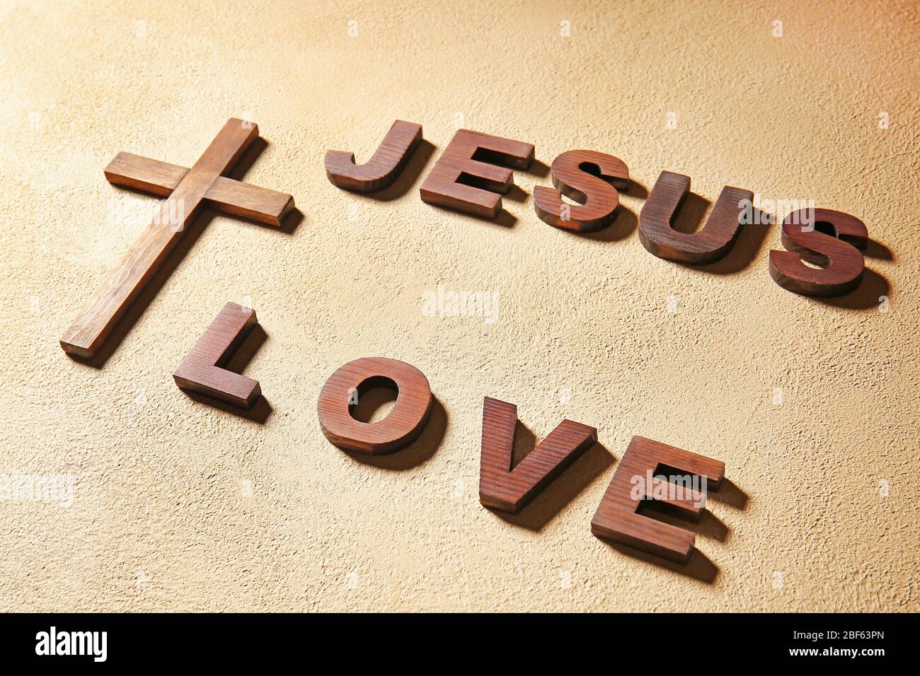 Christian cross and text JESUS LOVE on color background Stock Photo - Alamy