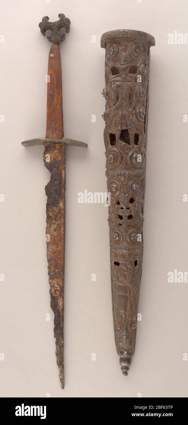 dagger. Long pointed blade, corroded. Curved rectangular guard. Tang ...