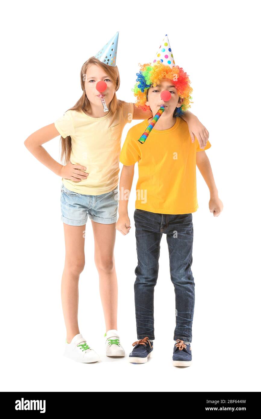 Little children in funny disguise and with party whistles on white ...
