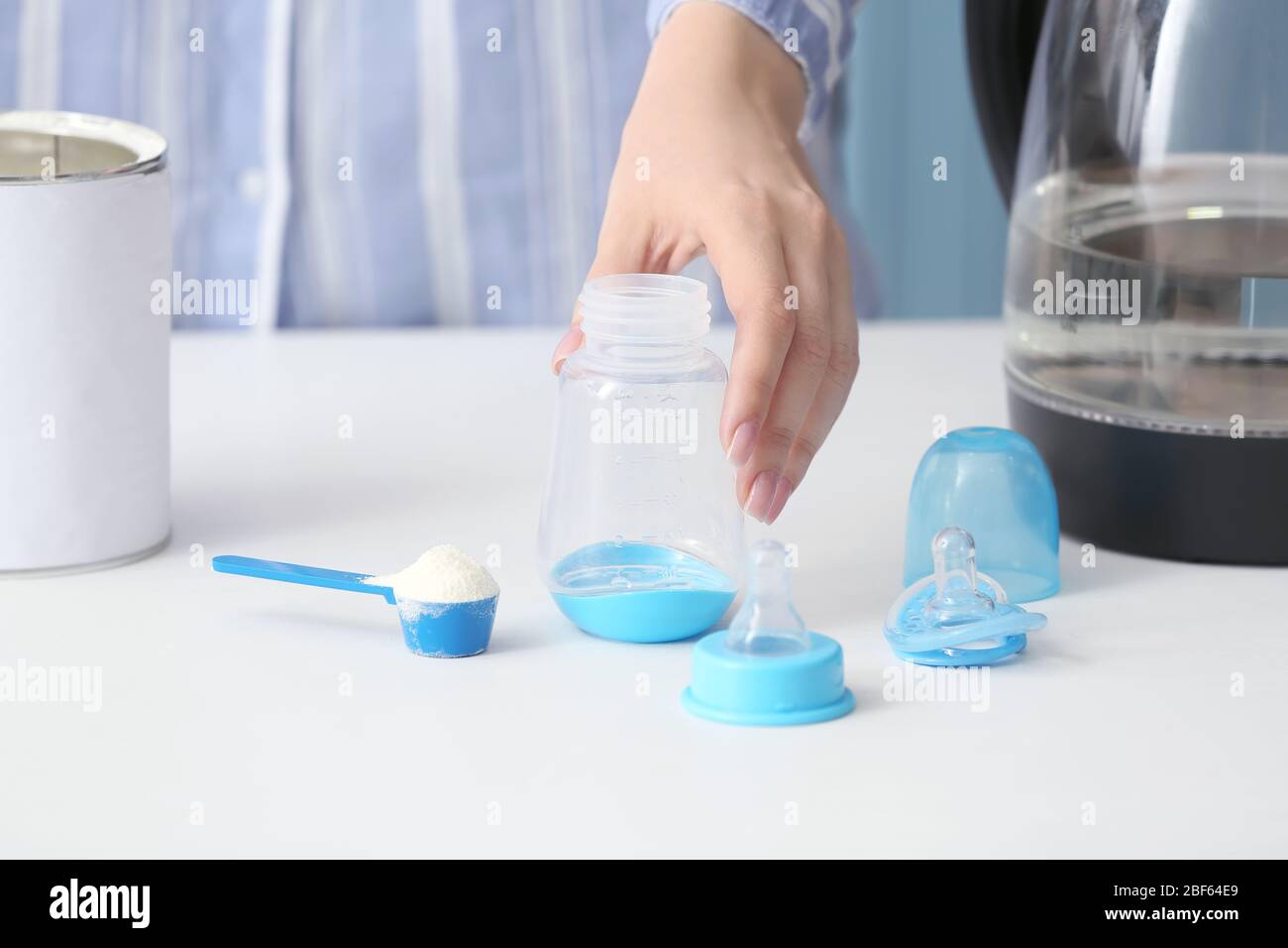 Woman preparing baby formula hi-res stock photography and images - Alamy