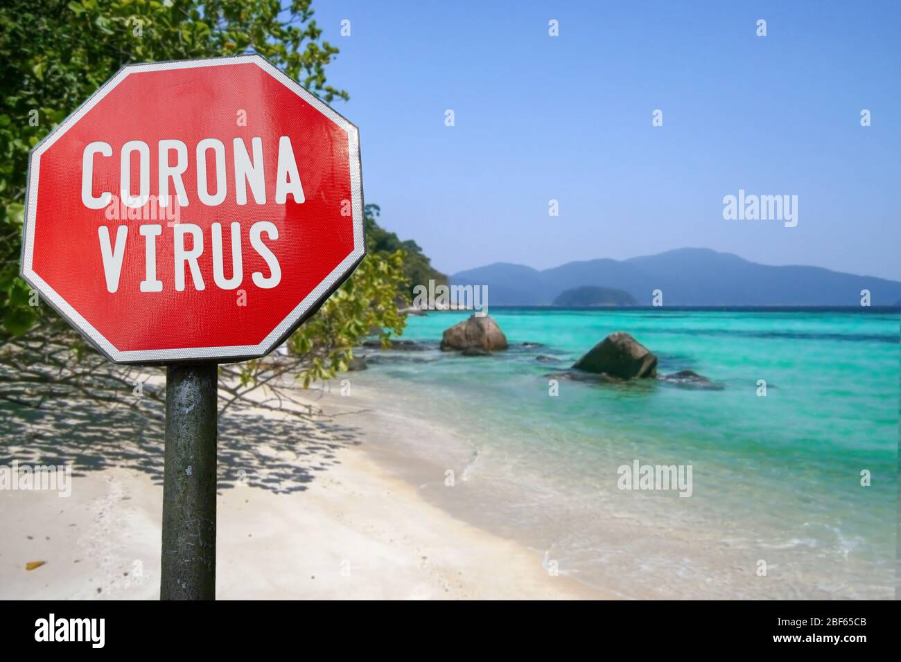 Corona virus stop sign with view of empty beach in Thailand. Warning ...
