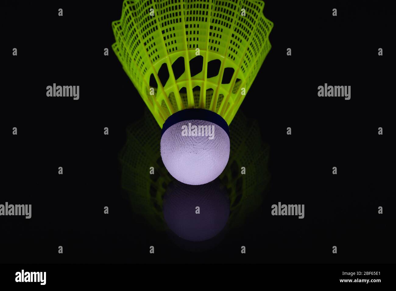 The yellow shuttlecock on the black background. Badminton shuttlecock ...