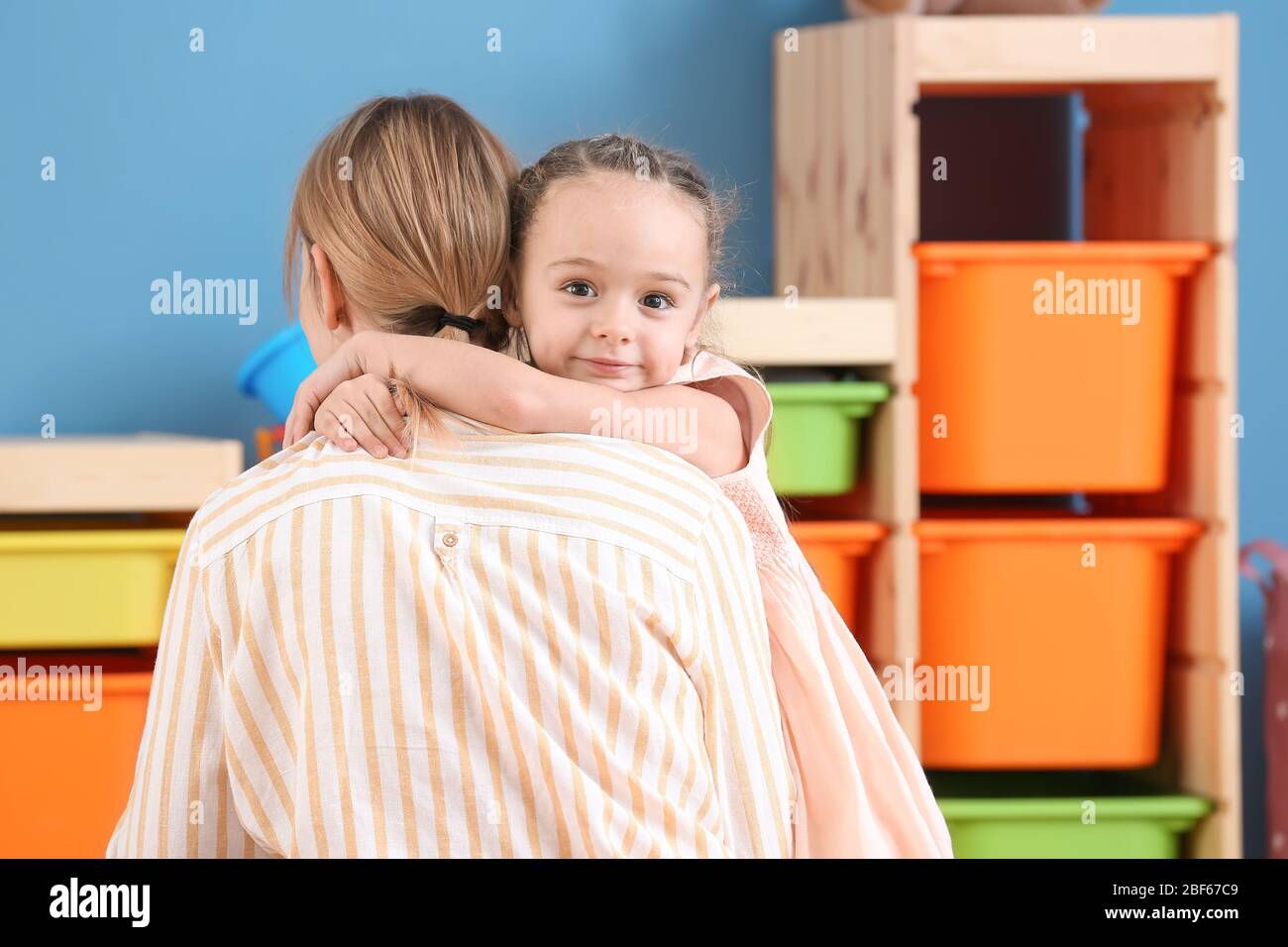 Nanny and cute little girl at home Stock Photo - Alamy