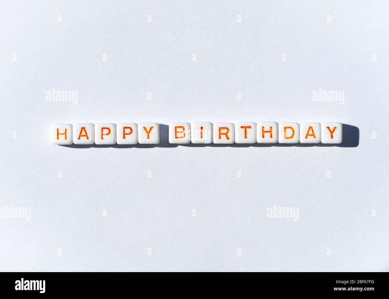 Happy Birthday postcard with cubes with orange letters on white ...