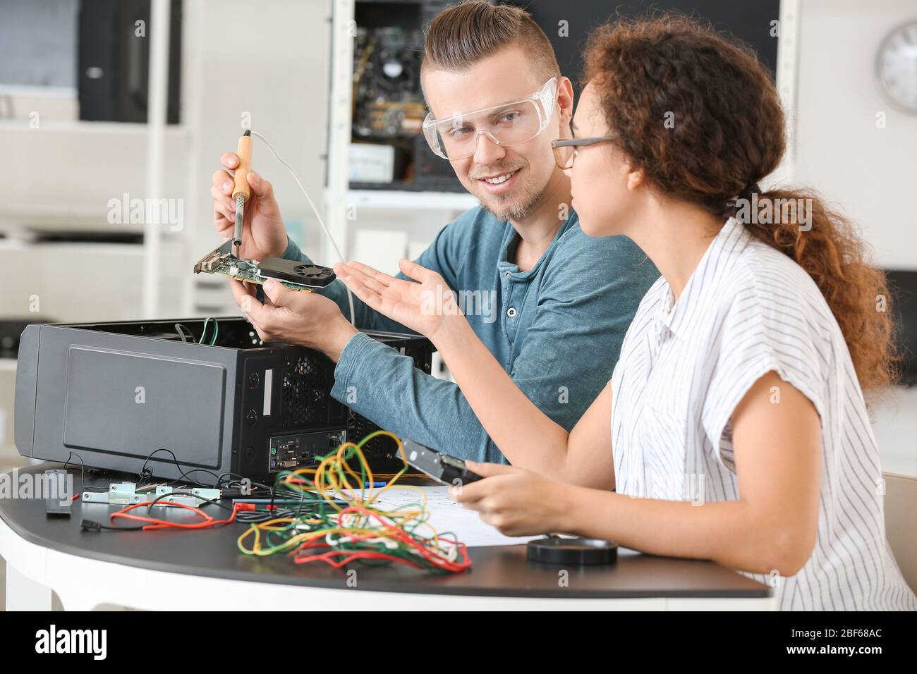 Electronic technicians working in service center Stock Photo - Alamy