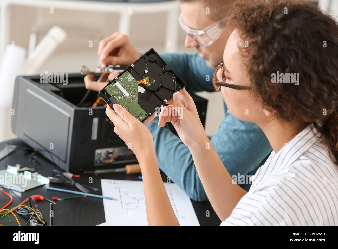 Electronic technicians working in service center Stock Photo - Alamy