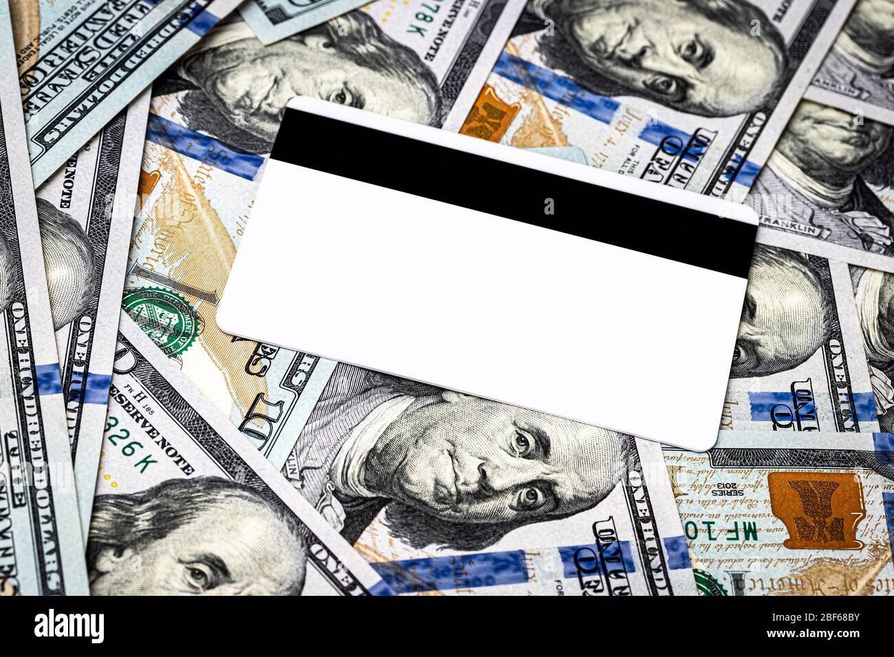 Dollar bills and white debit card with copy space for a text. The ...