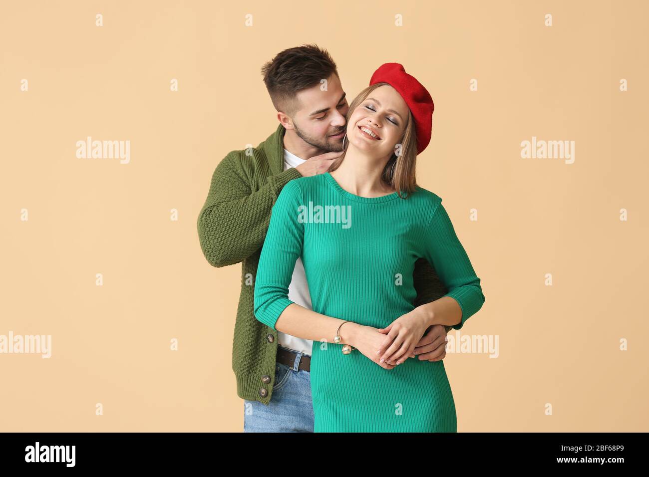 Happy young couple on color background Stock Photo - Alamy