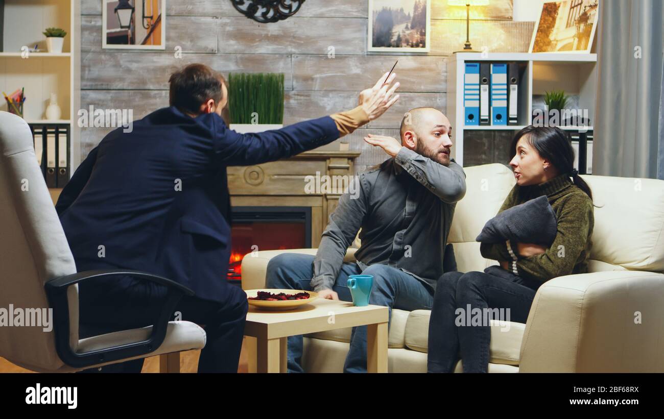 Angry man so mad at couple therapy trying to hit his wife. Bad marriage ...