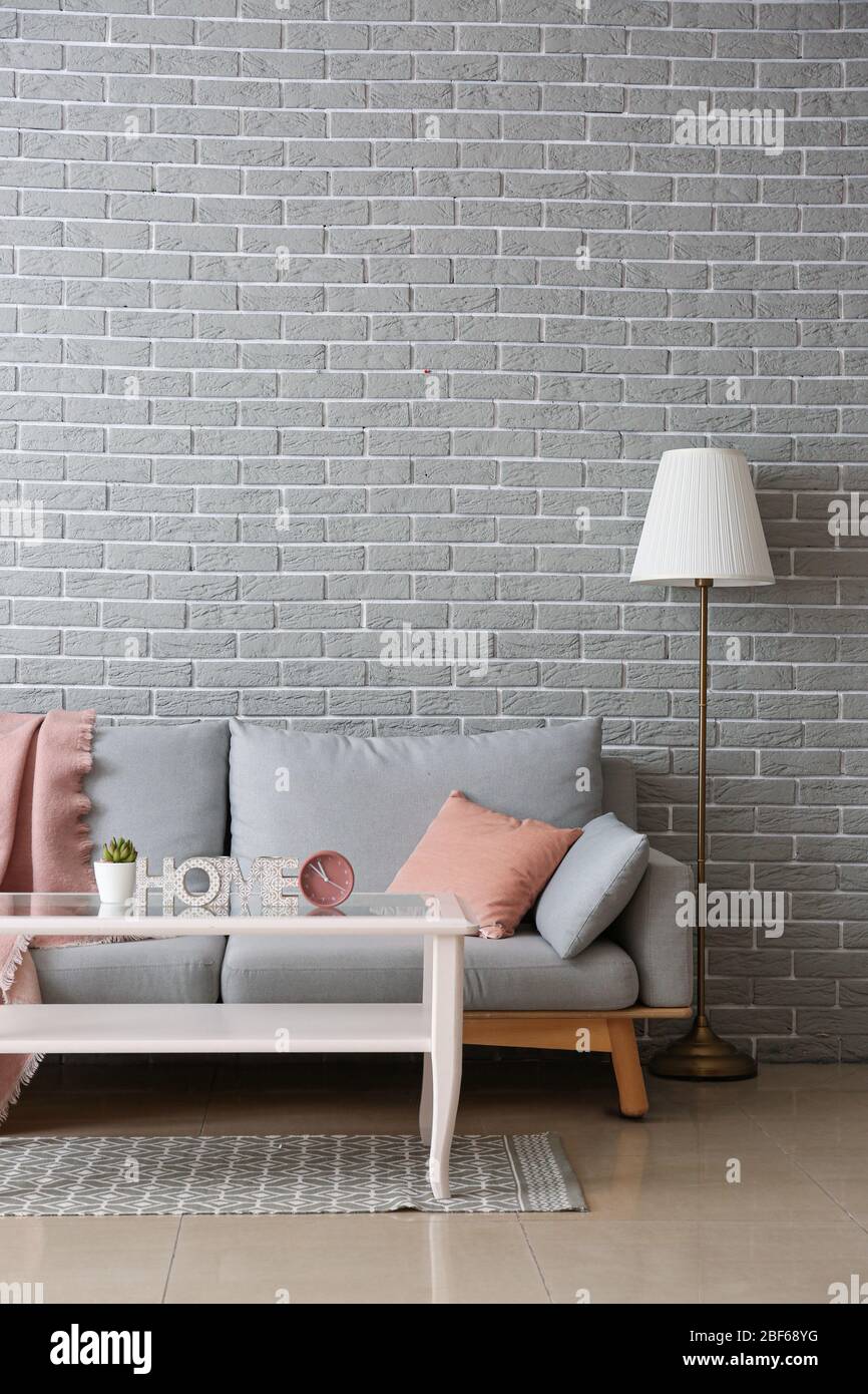 Interior of modern room with comfortable sofa and table Stock Photo - Alamy