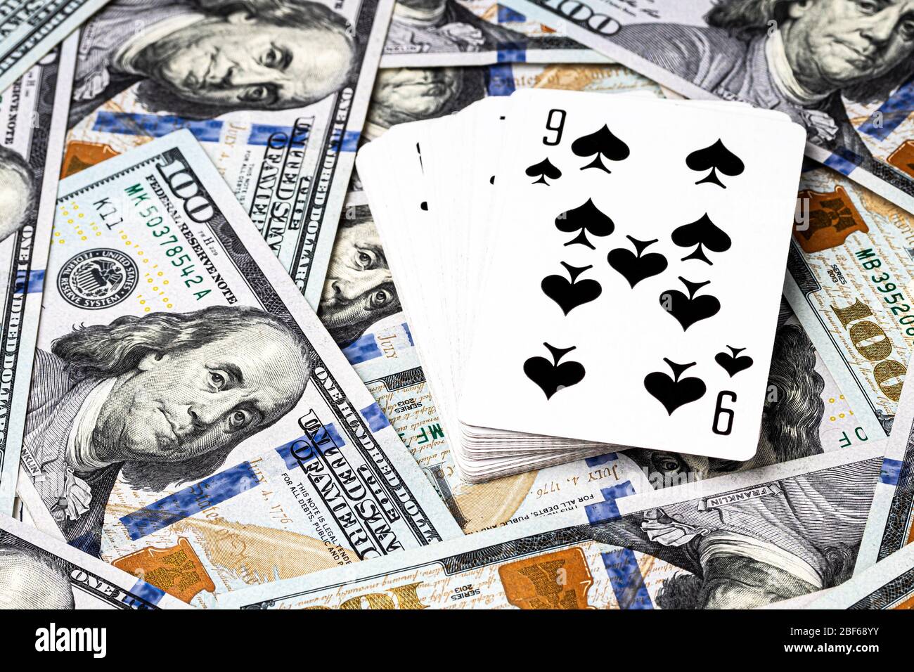 Hundred dollar bills and a deck of playing cards. Money gambling ...