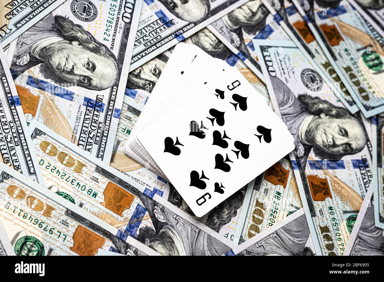Hundred dollar bills and a deck of playing cards. Money gambling ...
