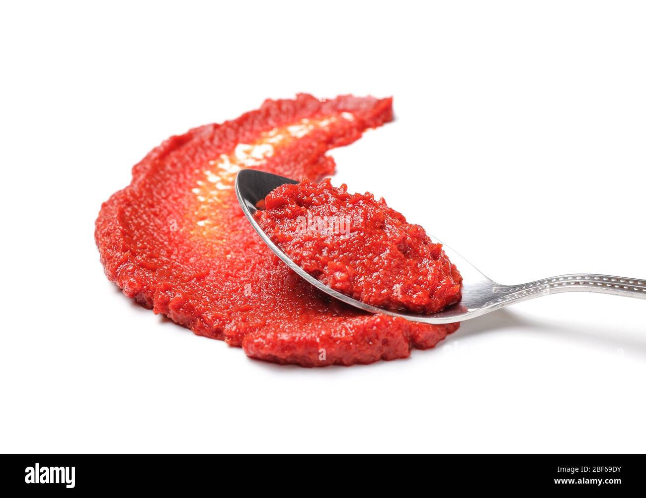 Tomato paste on spoon Cut Out Stock Images & Pictures - Alamy