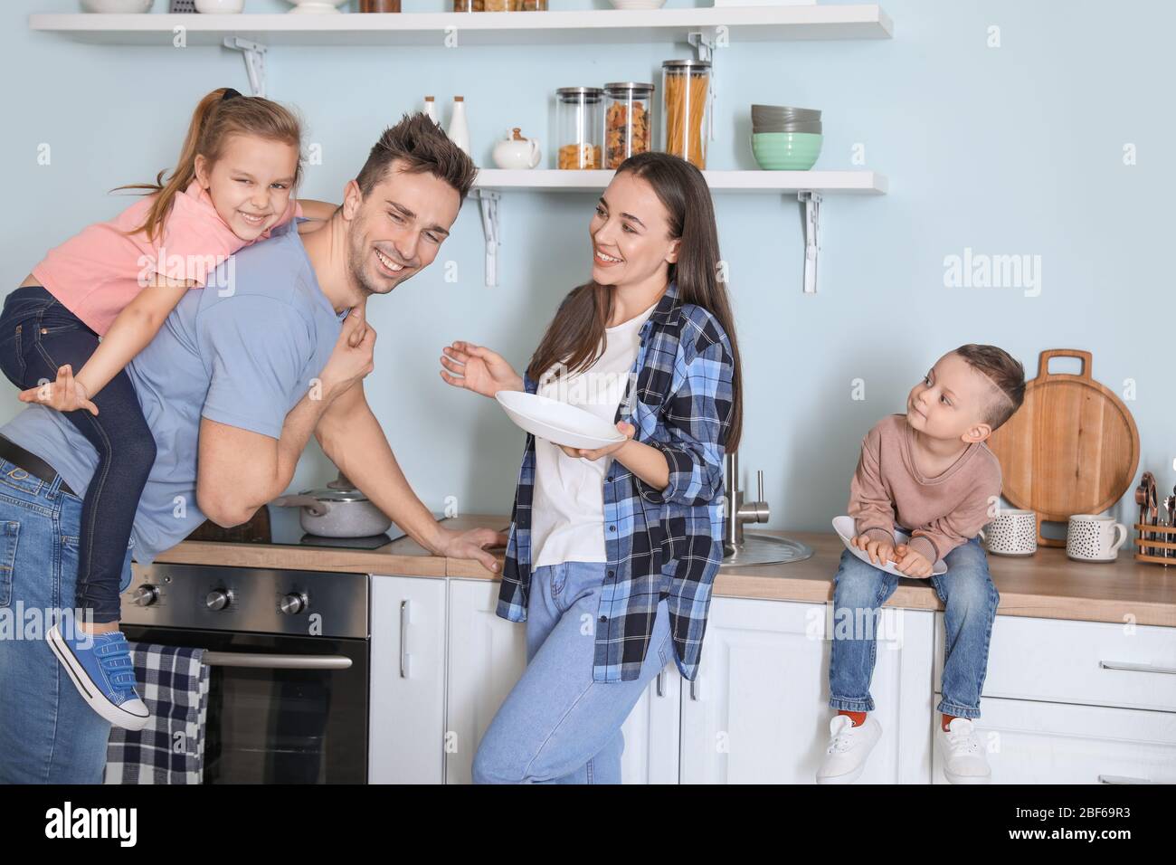 Young family washing dishes in kitchen Stock Photo - Alamy