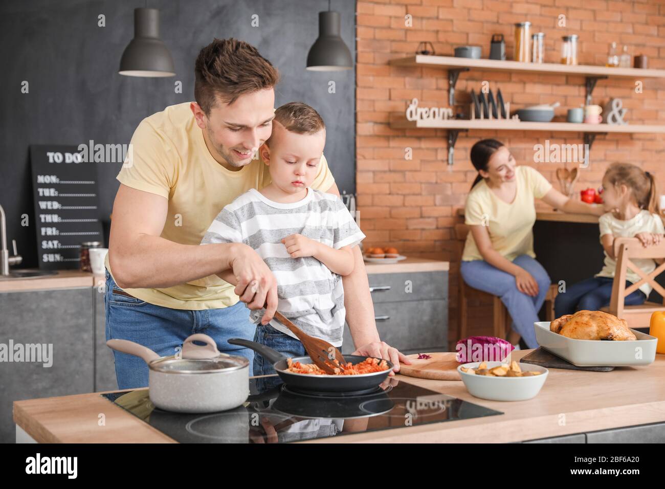 Father with son cooking together in kitchen Stock Photo - Alamy