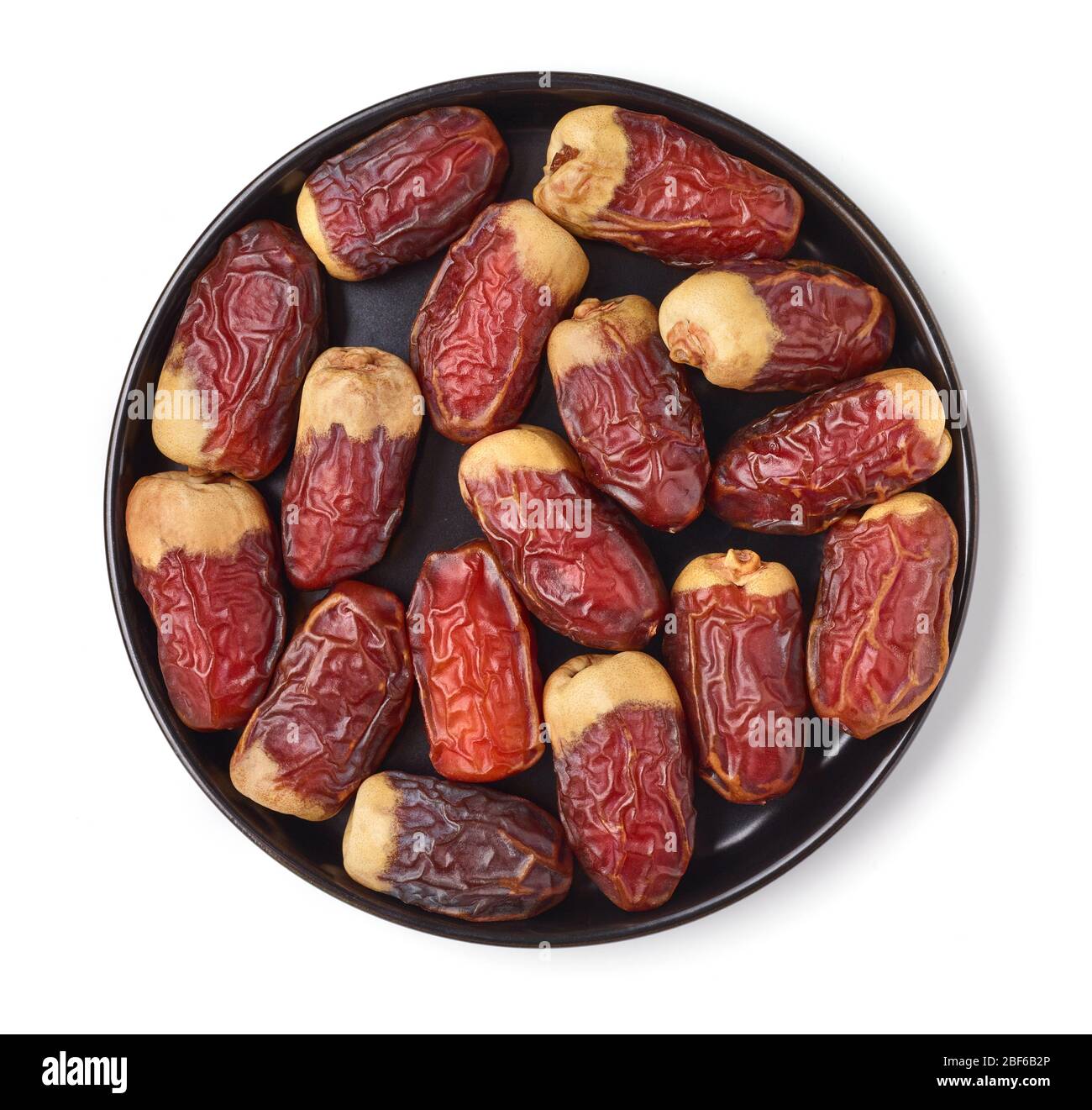 Black plate full of dates isolated on white background; top view Stock ...