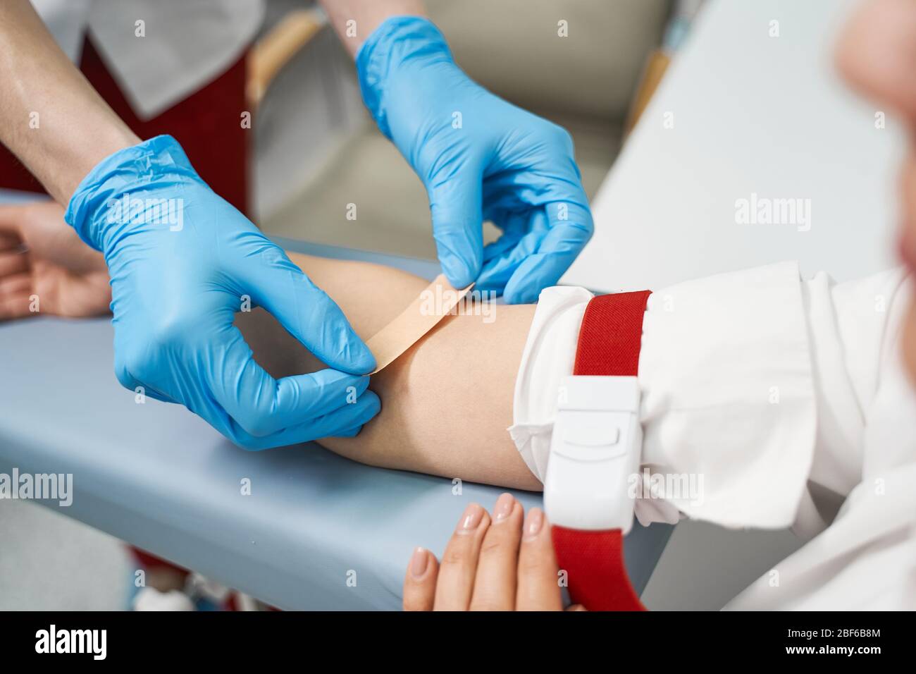 Professional medical worker putting plaster on arm Stock Photo - Alamy