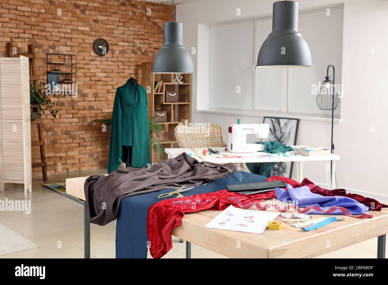 Interior of modern atelier with tailor's workplace Stock Photo - Alamy