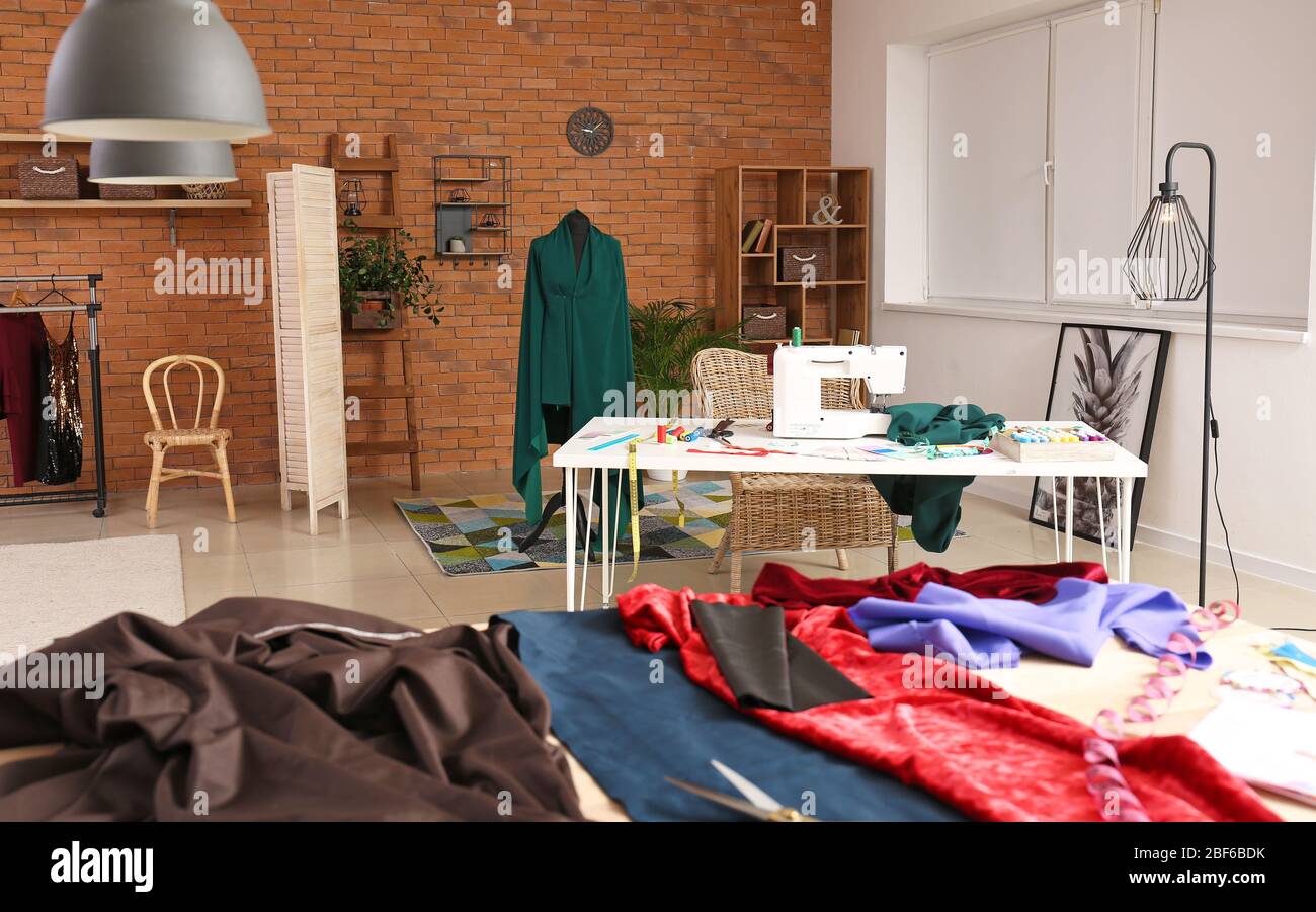 Interior of modern atelier with tailor's workplace Stock Photo - Alamy
