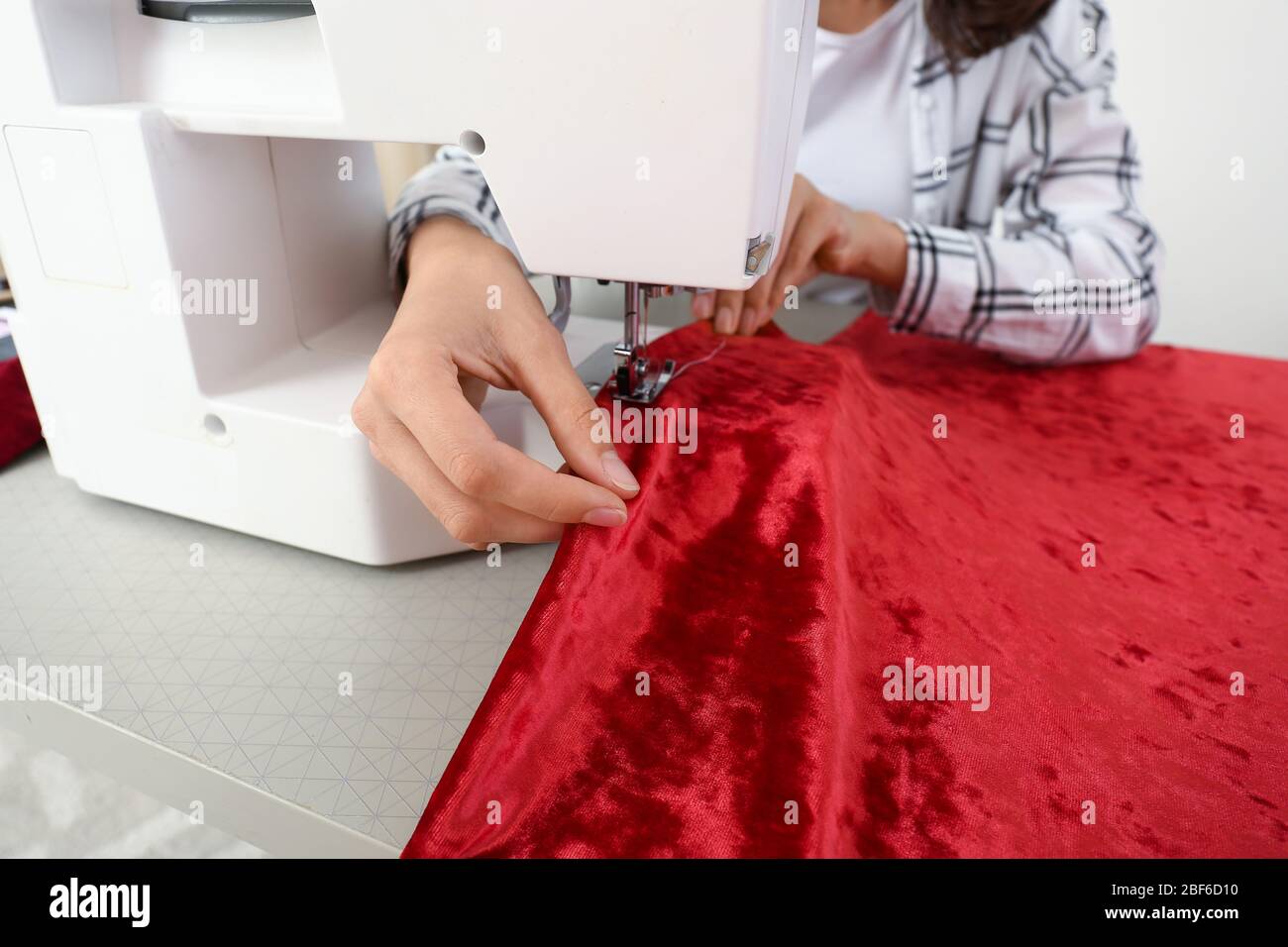Young woman sewing clothes in atelier, closeup Stock Photo - Alamy