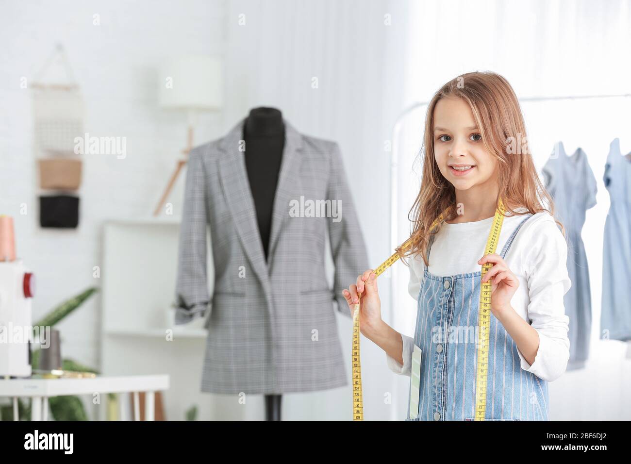 Cute little tailor in atelier Stock Photo - Alamy
