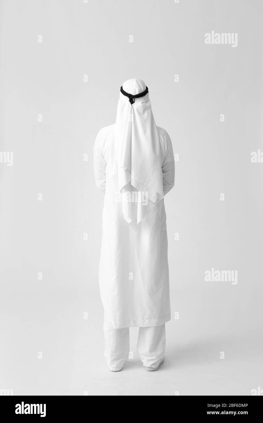 Handsome Arab man on light background, back view Stock Photo - Alamy
