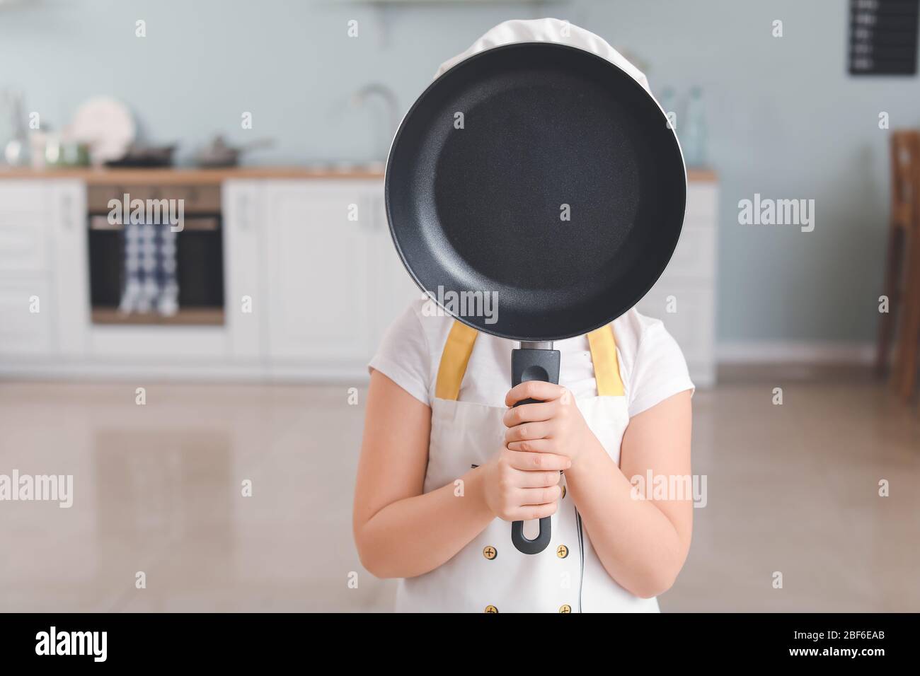 Cute little chef in kitchen Stock Photo - Alamy