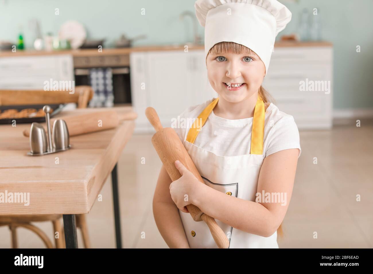 Cute little chef in kitchen Stock Photo - Alamy