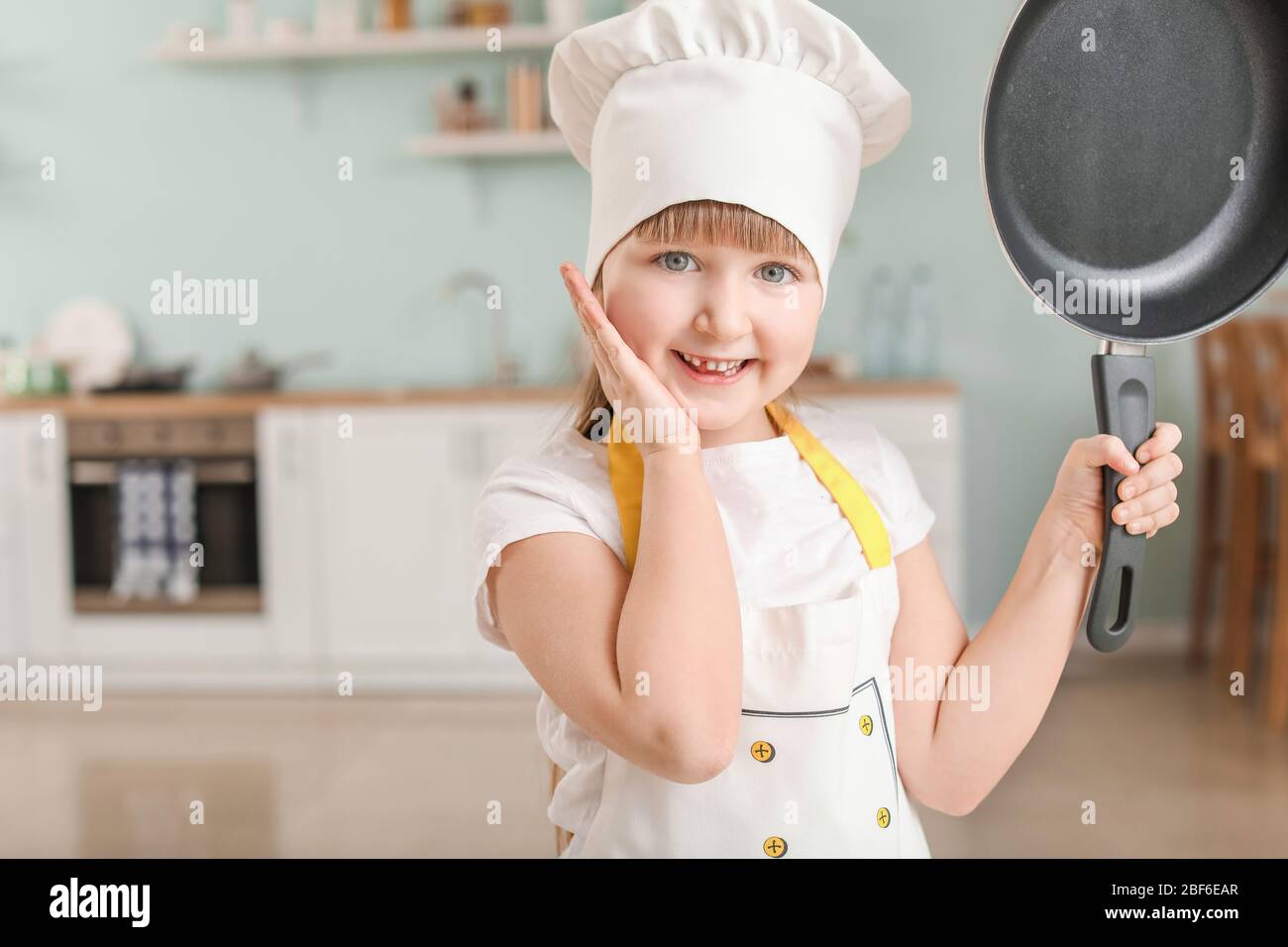 Cute little chef in kitchen Stock Photo - Alamy