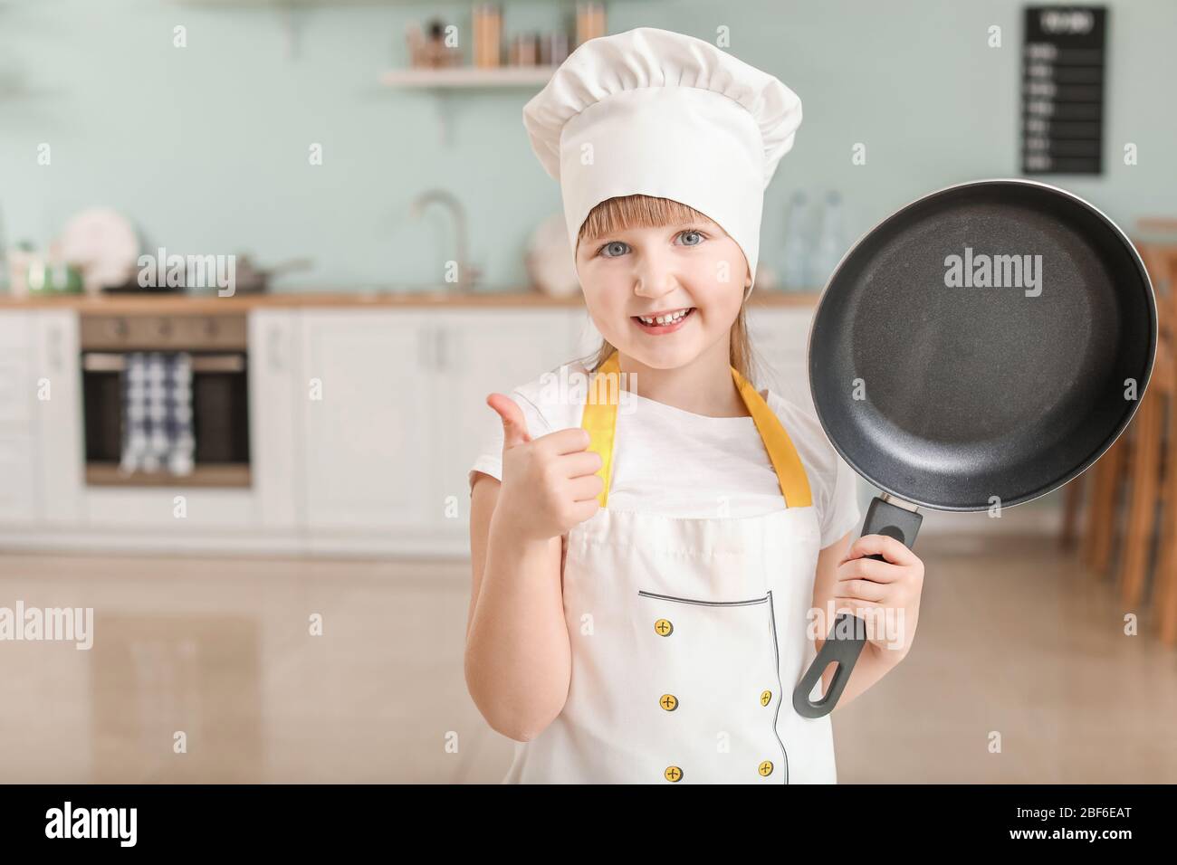 Cute little chef in kitchen Stock Photo - Alamy