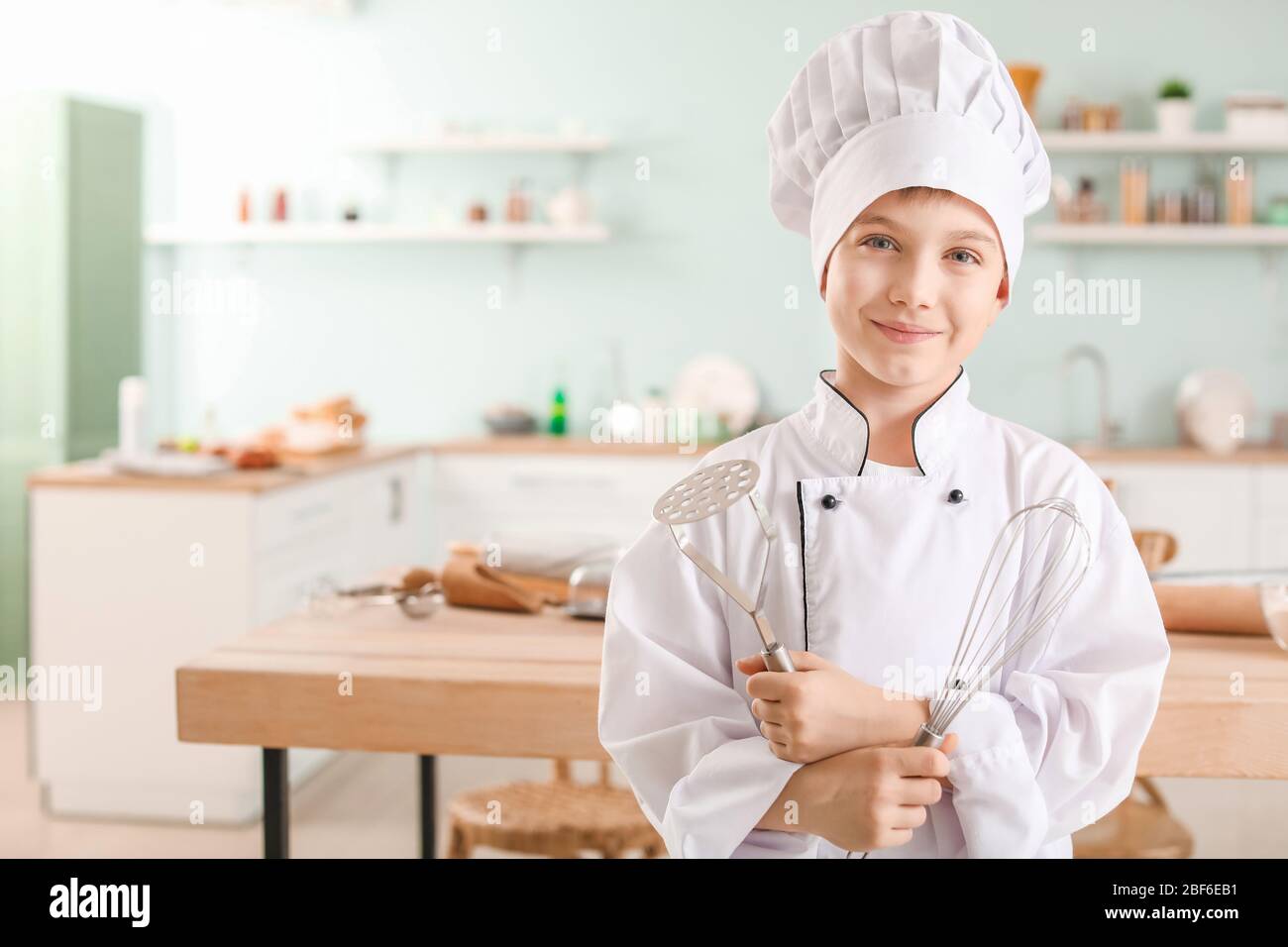 Cute little chef in kitchen Stock Photo - Alamy