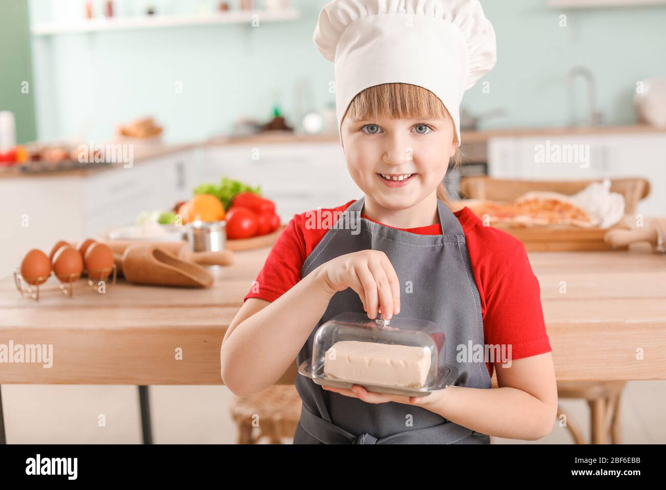 Cute little chef in kitchen Stock Photo - Alamy