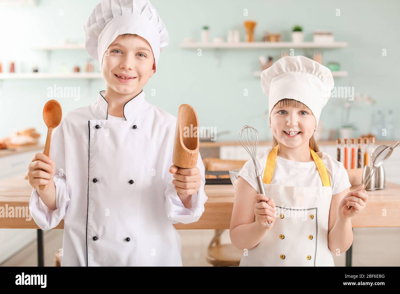 Cute little chefs in kitchen Stock Photo - Alamy