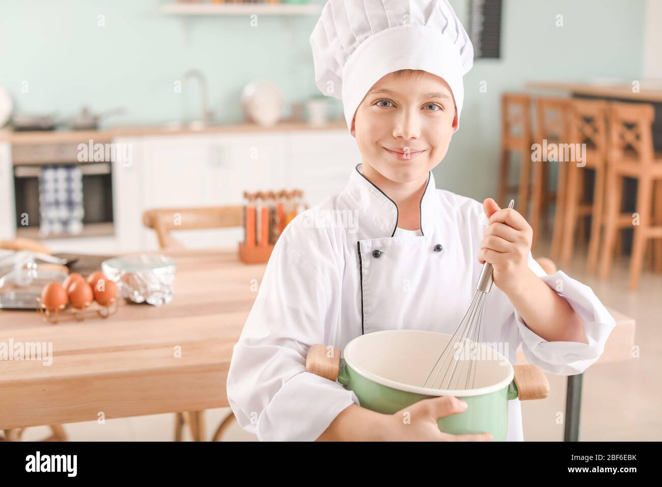 Cute little chef in kitchen Stock Photo - Alamy
