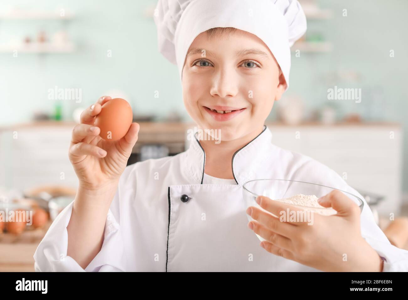 Cute little chef in kitchen Stock Photo - Alamy