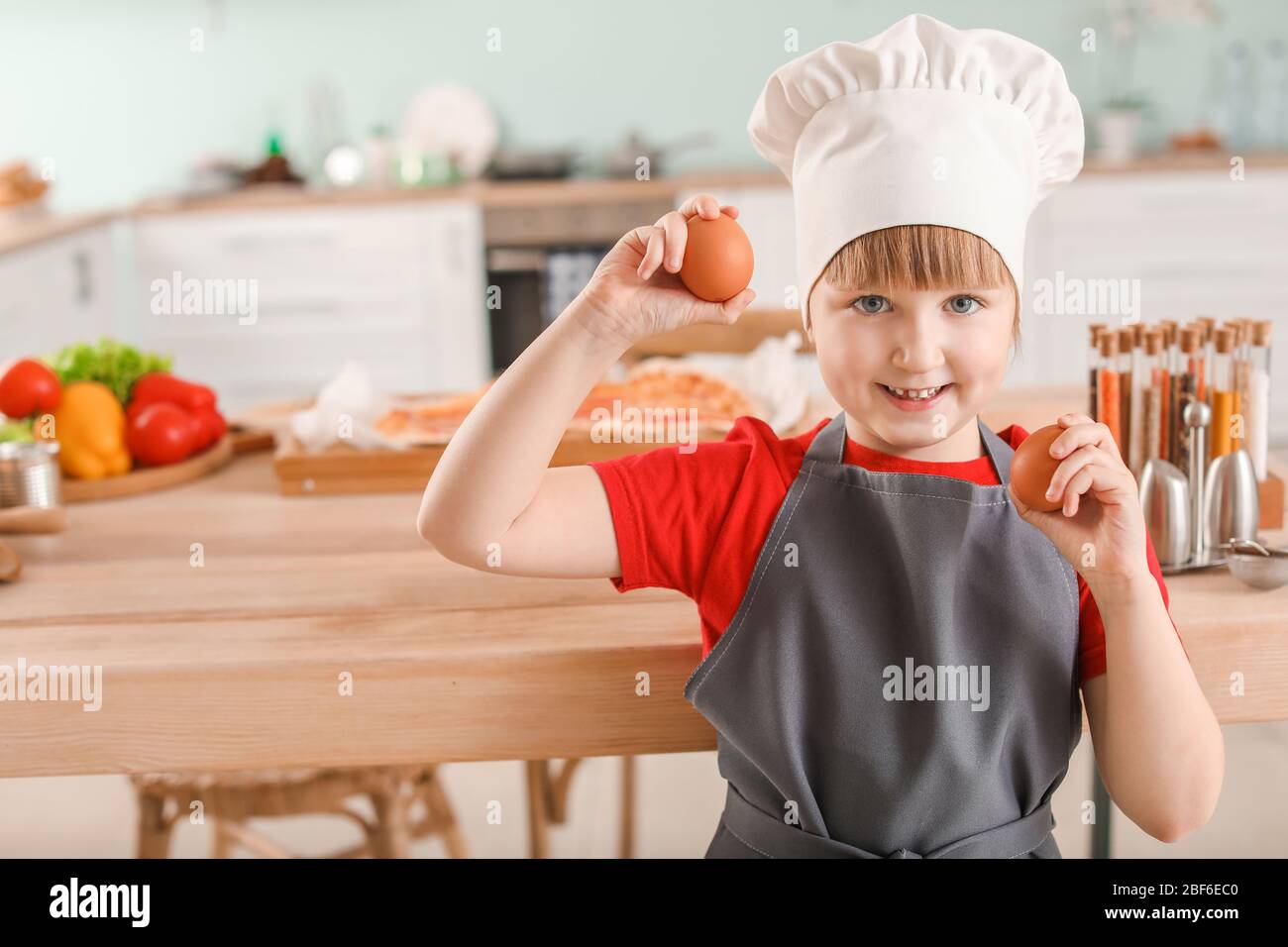Cute little chef in kitchen Stock Photo - Alamy